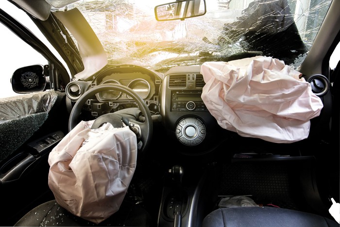 What chemicals make airbags inflate, and how have they changed over time?